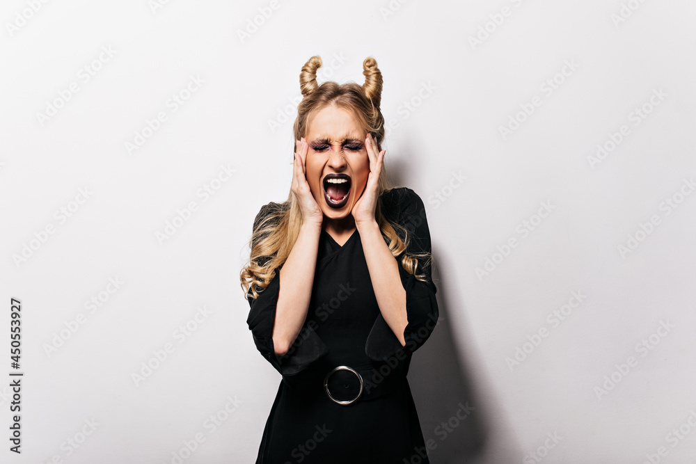 Angry vampire with long hair posing in halloween. Blonde woman ...
