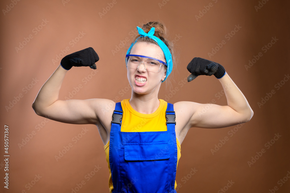 Portrait of a strong attractive Caucasian young woman in construction ...