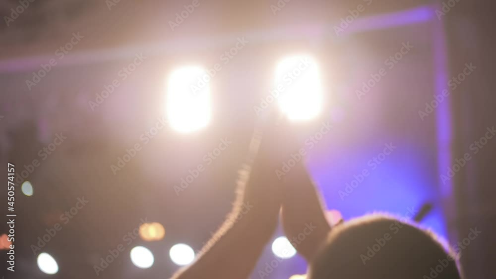Slow motion: man partying, cheering, raising hands up and clapping at ...