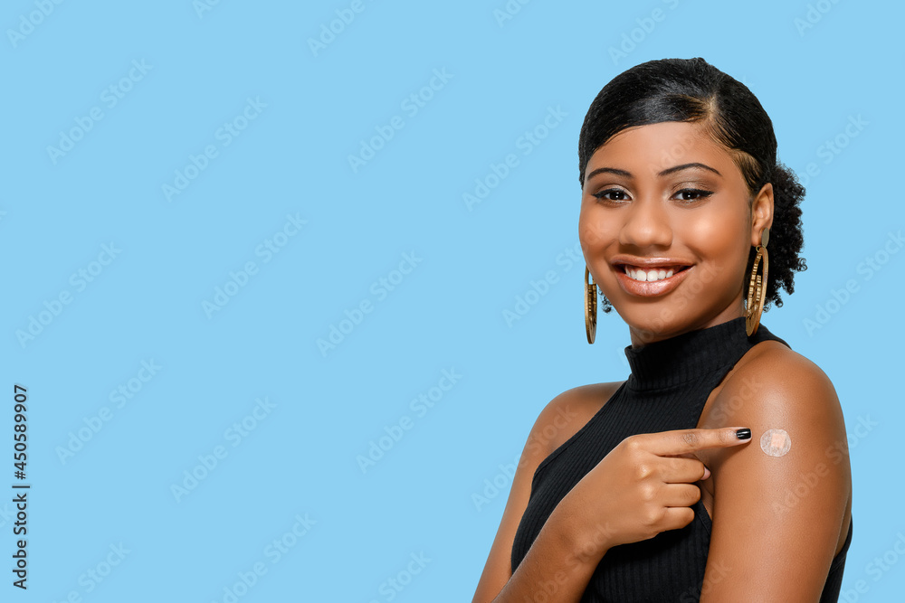 black teenage girl smiling happily and showing the vaccine mark on her ...