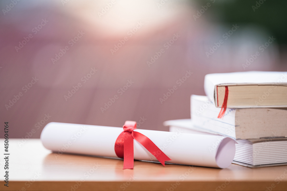 Cropped photo of a university graduation hat mortarboard and diploma ...