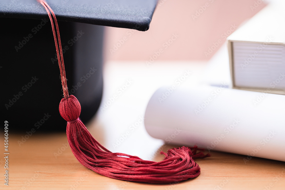 Cropped photo of a university graduation hat mortarboard and diploma ...