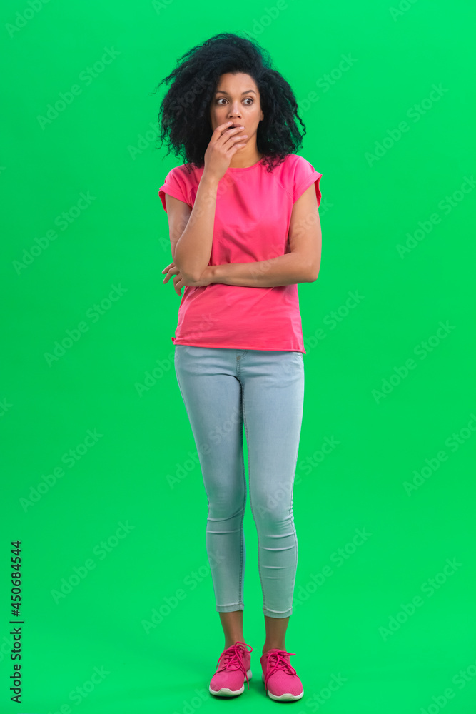 Portrait of young female African American looks frightened to the side. Black woman with curly ...