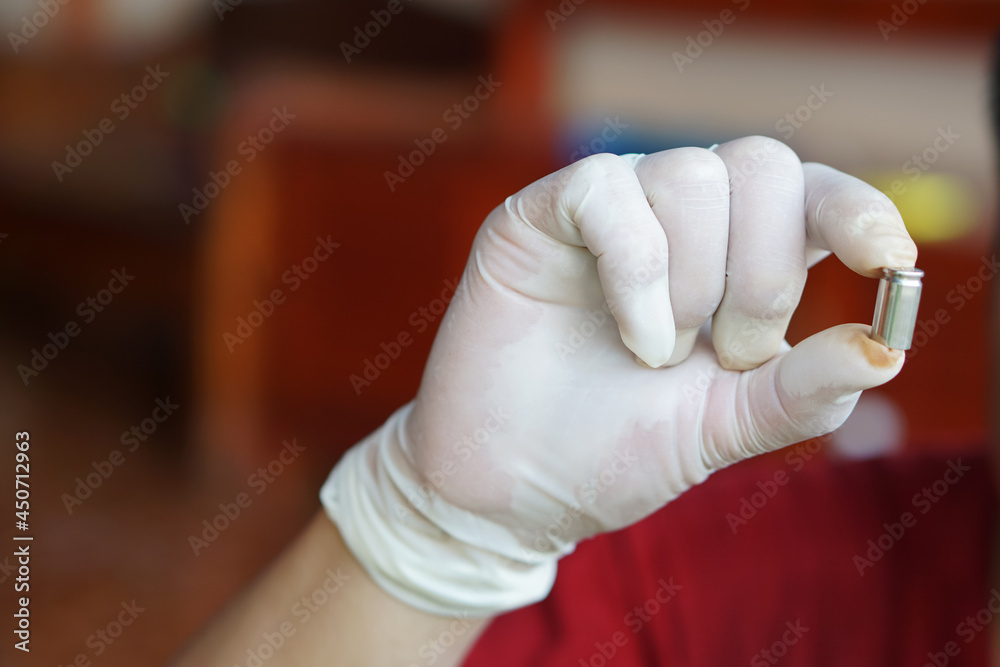 Concept : Crime evidence investigation. Detective wears glove in hand ...