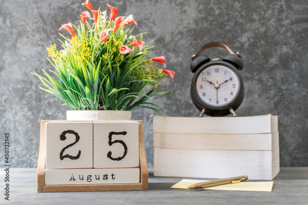 August 25th. August 25 wooden cube calendar with blur objects on ...