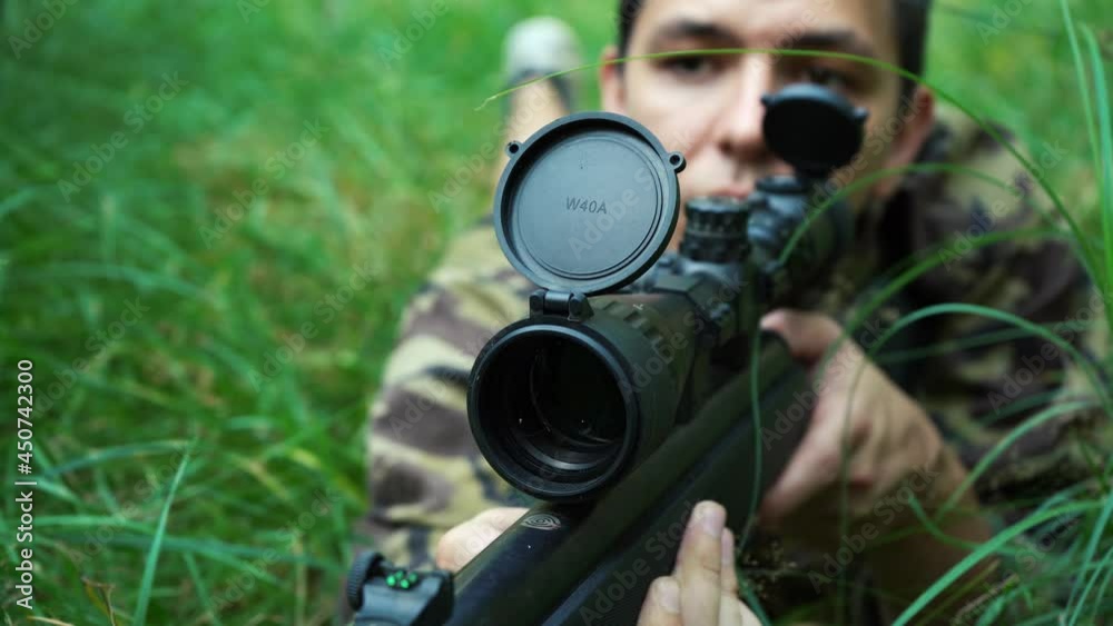 male sniper looking through the scope of his sniper rifle Stock ビデオ ...