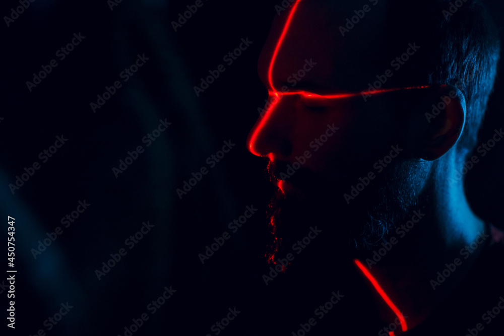 Man in dark with face illuminated by scan red laser on contour. Stock ...