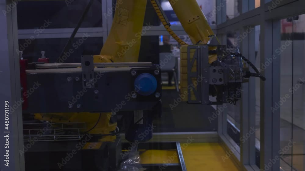 Robotic mechanism transporting automatically small yellow briquettes ...