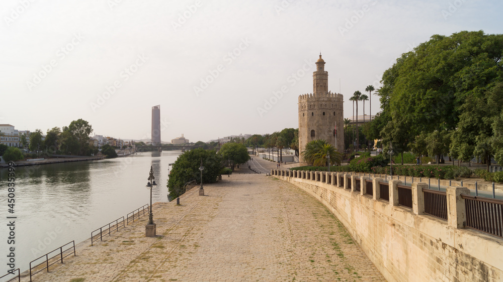 Views of the promenade along the Guadalquivir river, the Torre del Oro ...