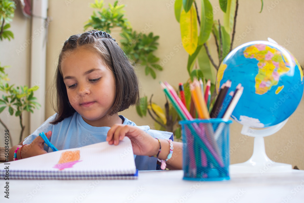 6 Year Old Girl Doing School Crafts.She Is Cutting It With A Scissors ...