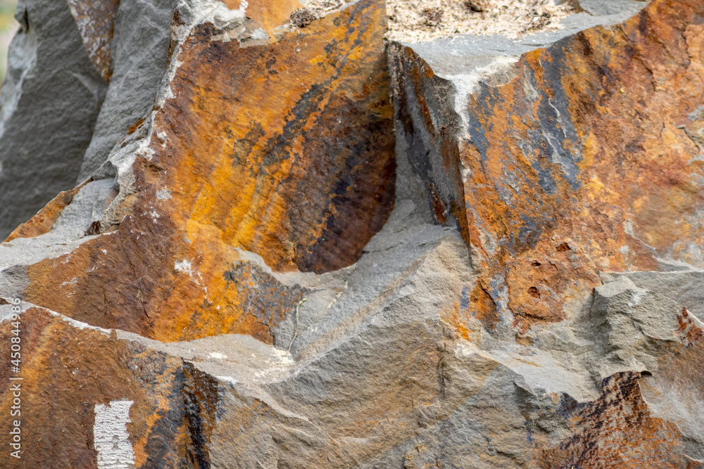 Raw rock in orange with minerals and metals as natural stones ...