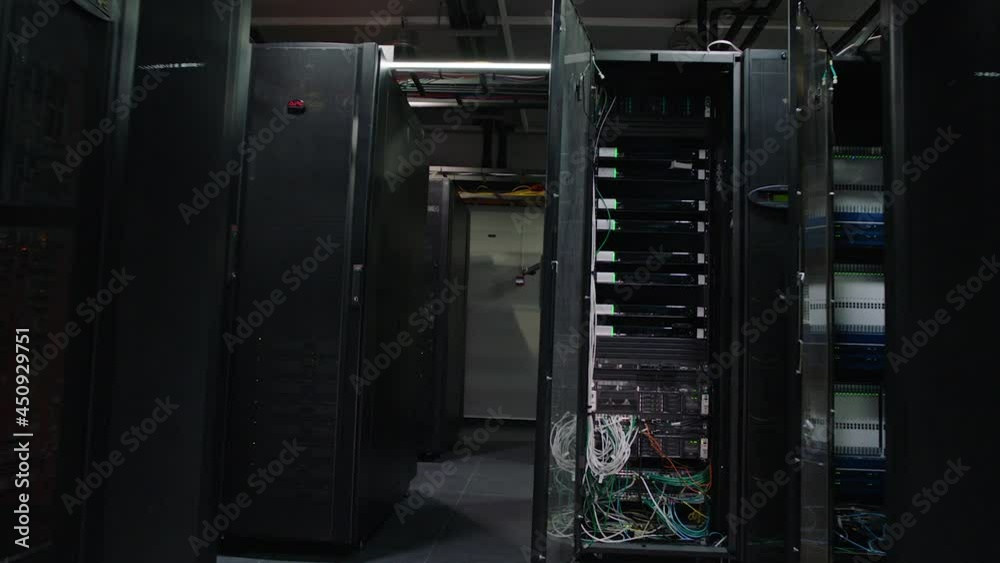 Camera moves through big working data center with server racks . Real ...