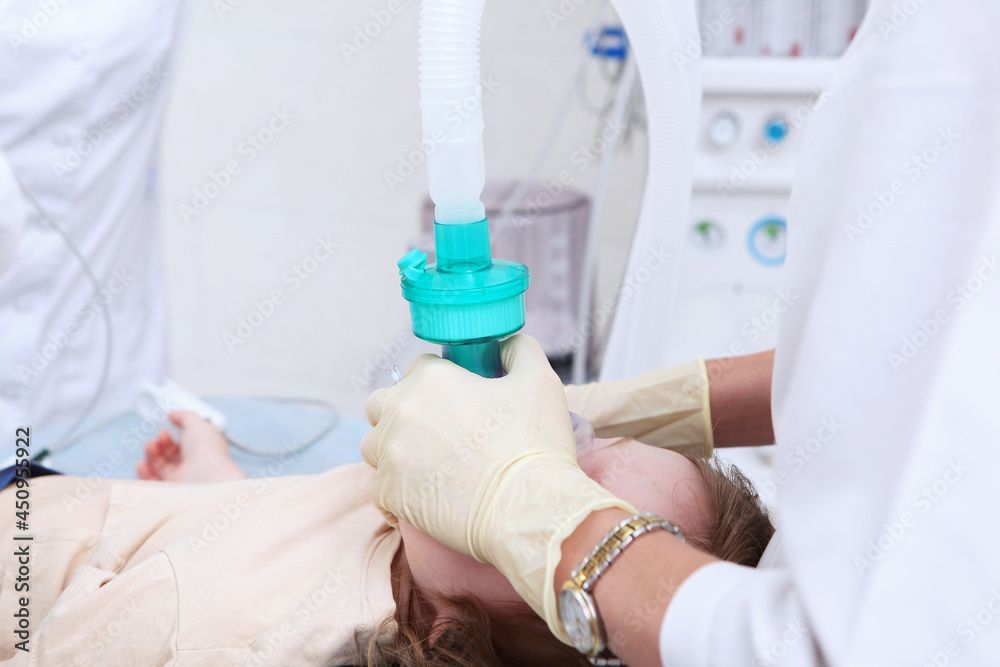 The resuscitator holds an oxygen mask on the child's face. General ...