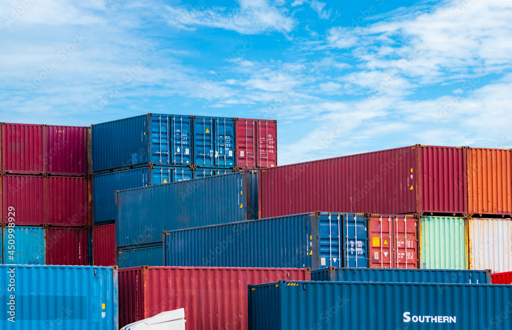 Red and blue logistic container against blue sky. Cargo and shipping ...