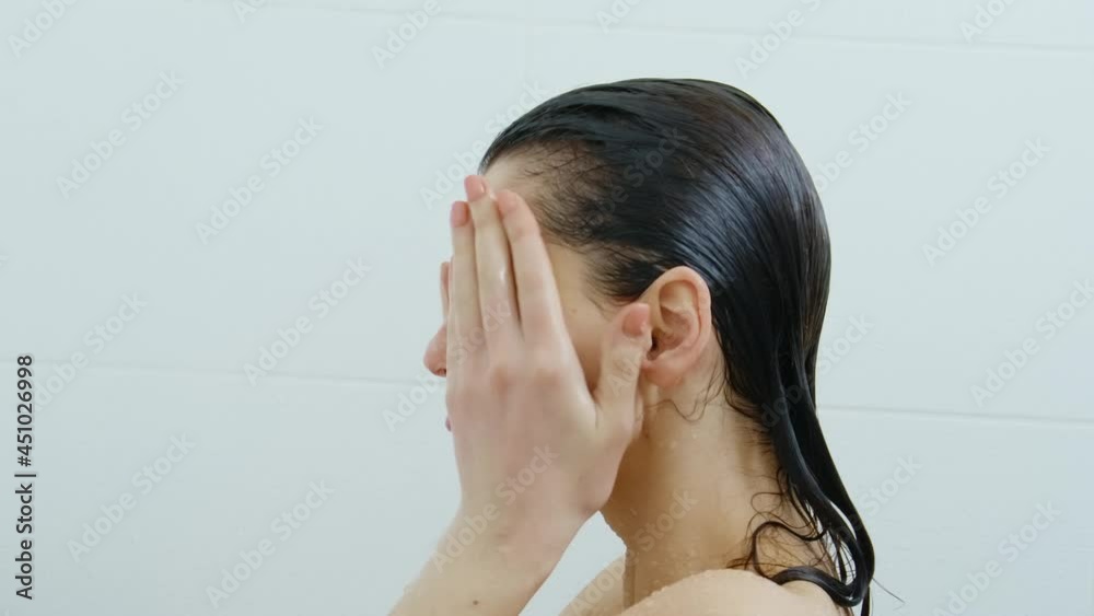 Close up young pretty woman washing face and body in clean water in ...