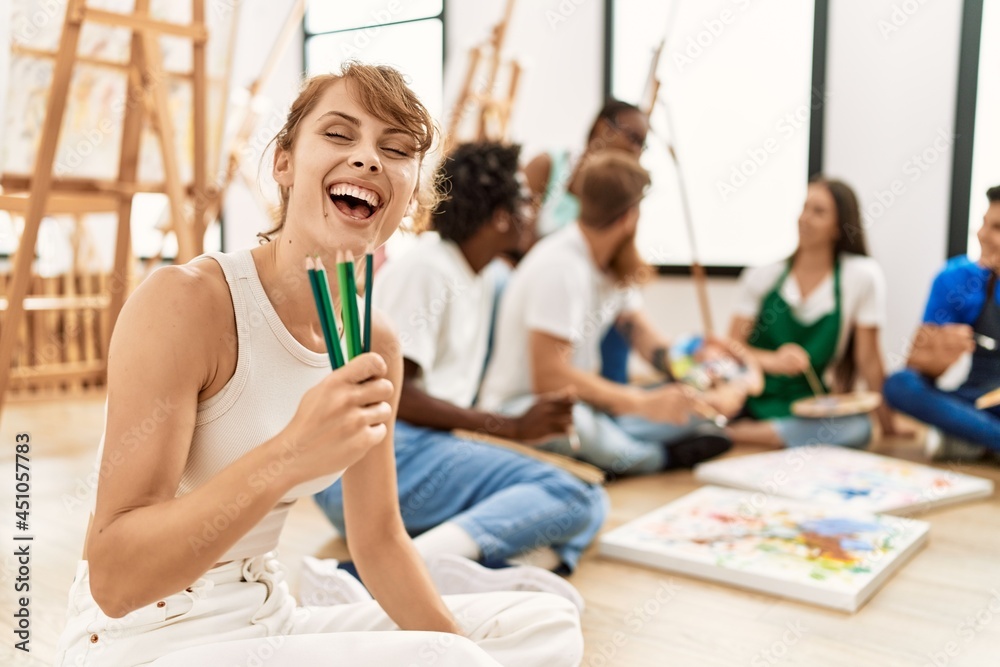 Group of people smiling happy drawing sitting on the floor at art ...