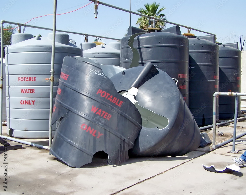 Stockfoto Plastic water tank damaged by a mortar blast on a camp in ...