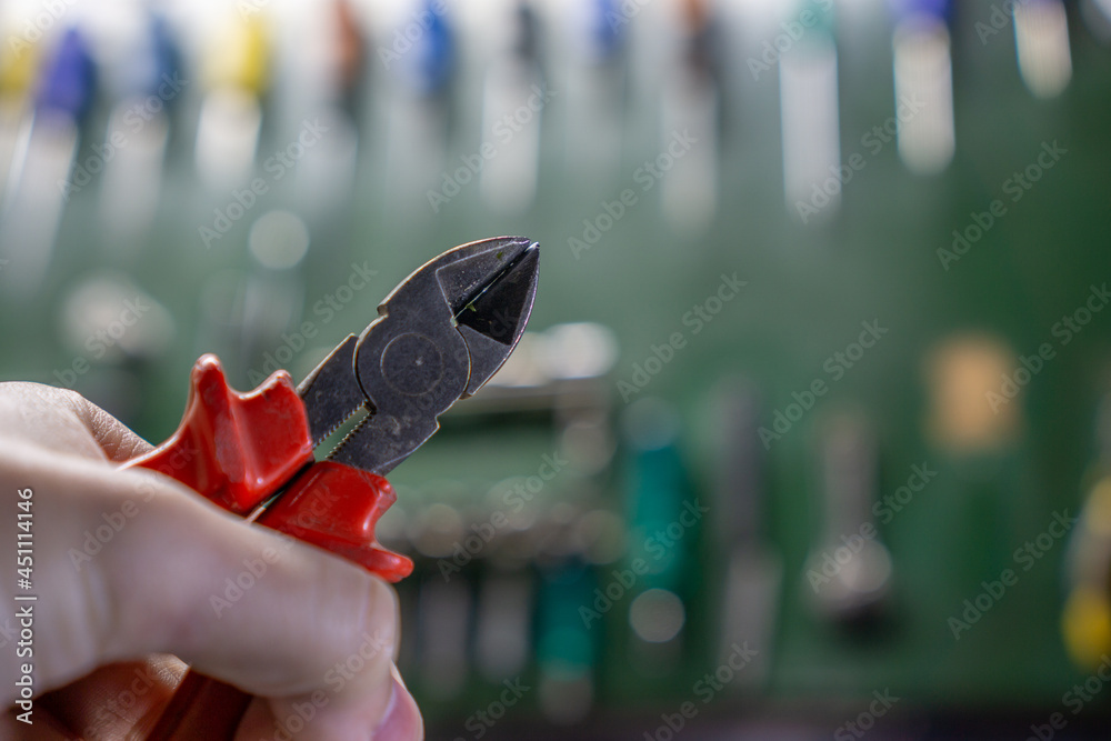 pliers of different types on a work table and a board Stock Photo ...