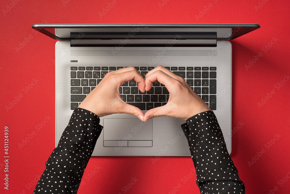 Overhead photo of grey laptop and hands with gesture as heart isolated ...