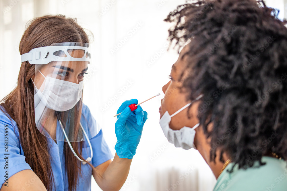 Doctor wearing personal protective equipment performing a Coronavirus ...