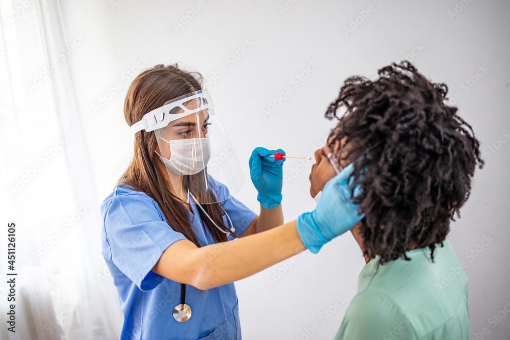 Close-up of young woman getting PCR test at doctor's office during ...
