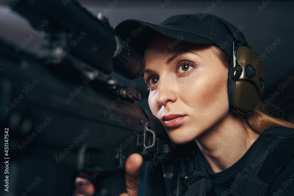 Beautiful concentrated lady firing an assault rifle Stock Photo | Adobe ...