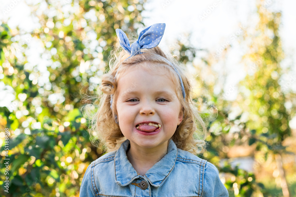 Little girl child little girl shows grimace with chewed away food and ...