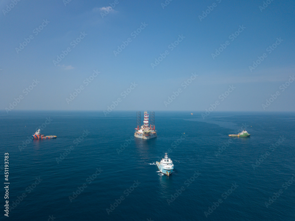 Offshore drilling rig (jack up rig) and tow vessels during the rig move ...