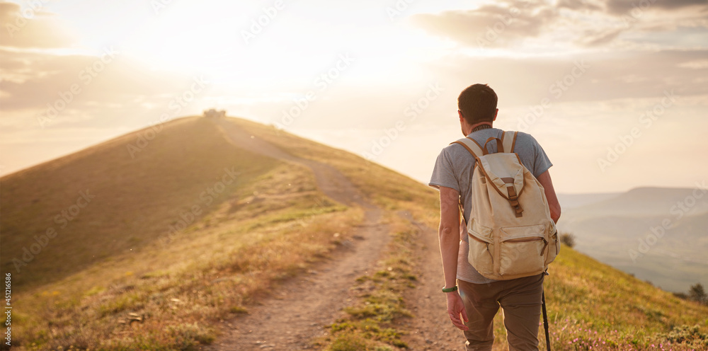 Young man travels alone walking on trail and enjoying on view of ...