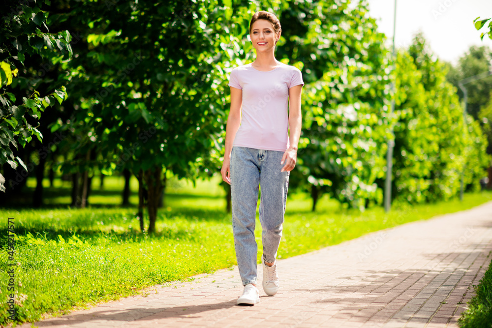 Full length body size view of attractive cheerful girl walking street ...