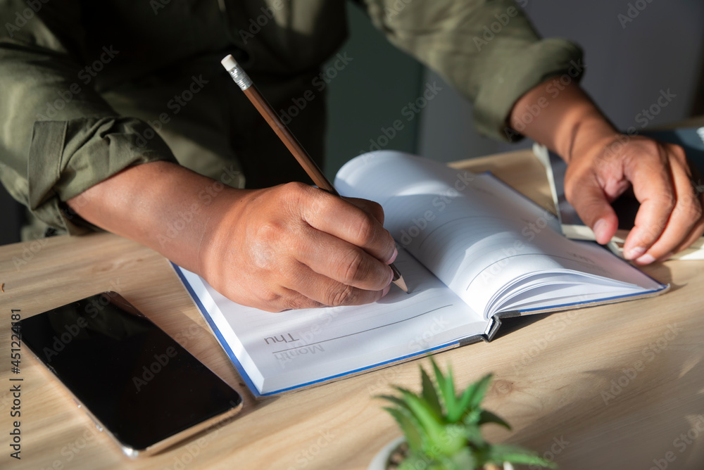 Male hand of planner writing daily appointment On Calendar book ...