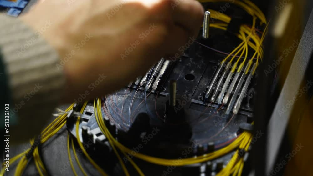 Worker welds optical line internet wire with welding machine. Service ...