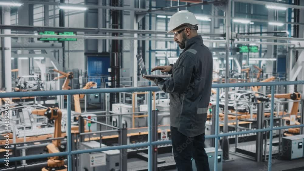 Car Factory Engineer in Work Uniform Using Laptop Computer. Automotive ...