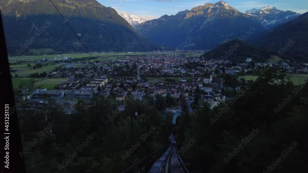Red Funicular Train driving downhill from Harder Kulm, Top of ...