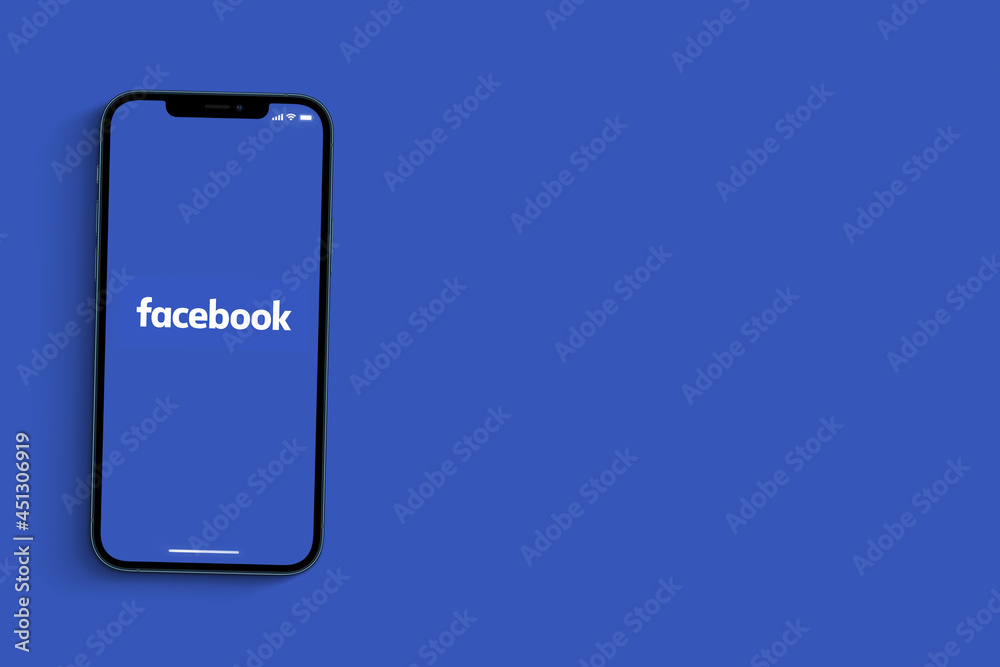 Facebook app on smartphone screen on blue background. Social media from ...