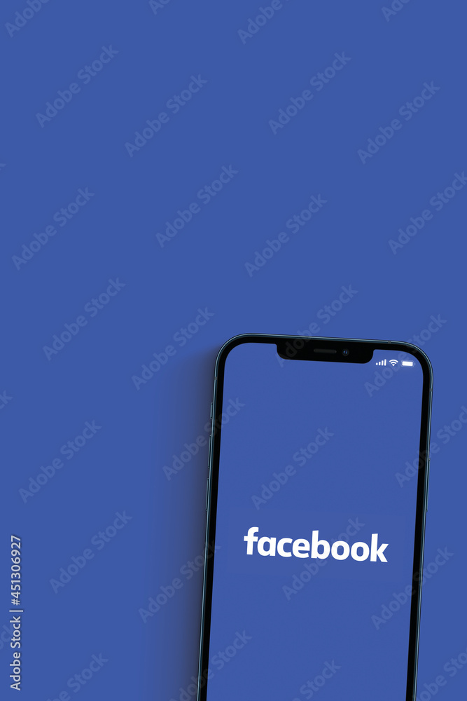 Facebook app on smartphone screen on blue background. Social media from ...