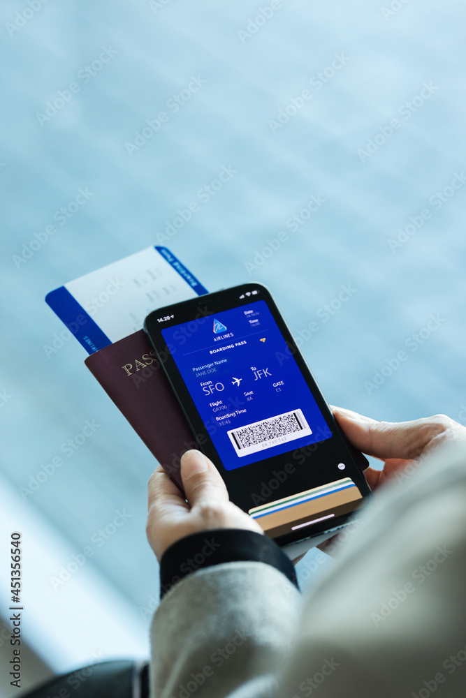 Traveler at airport using digital boarding pass phone app Stock Photo ...