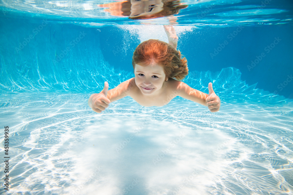 Underwater child swim in water swimming pool has fun under water on ...