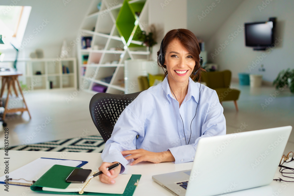 Attractive businesswoman having online meeting while working at the ...