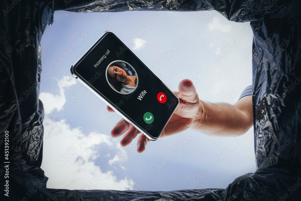 male hand holding smart phone with incoming call from wife and throwing ...