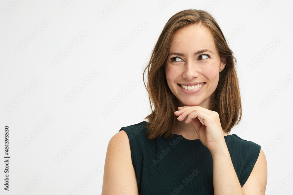 portrait of a cute young woman looking to the left while being ...