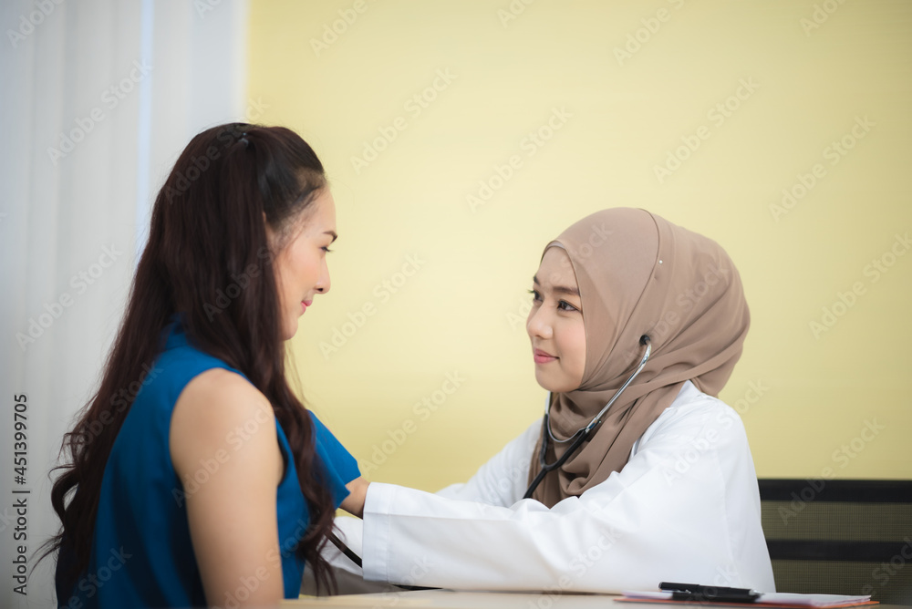 muslim women wearing brown hijab using stethoscope for medical check-up ...