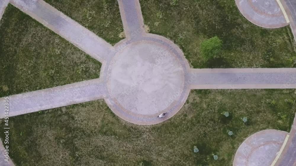 Top view bicycle woman riding a bike on round road in city park. Young ...
