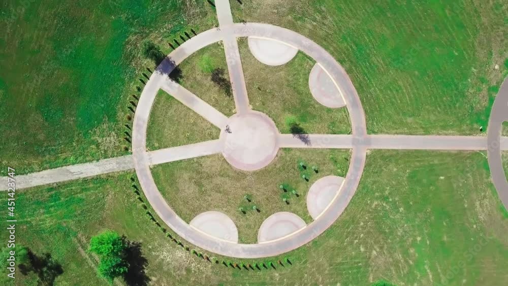Top view bicycle woman riding a bike on round road in city park. Young ...