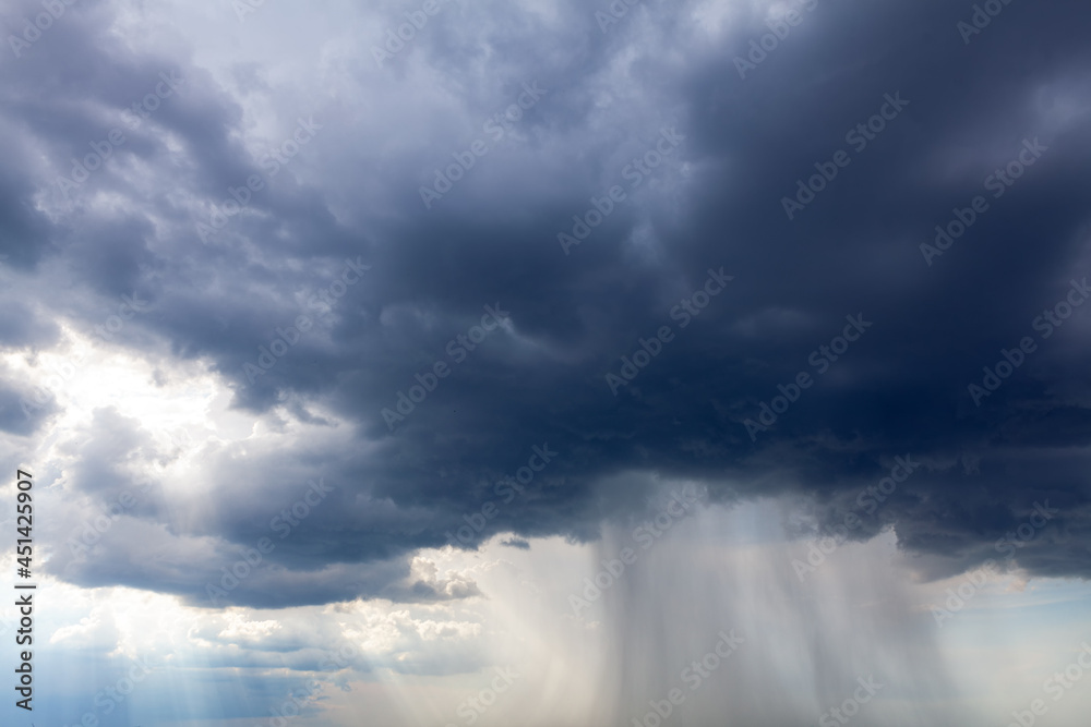 Dark clouds with torrential rain . Heavy rain stream from black clouds ...
