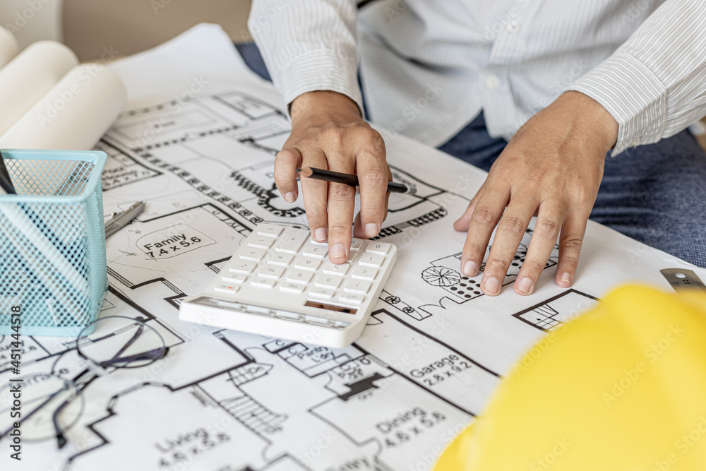 The architects pressed a calculator to calculate the area in a ...