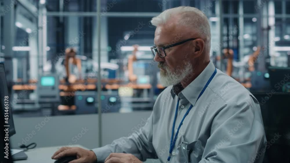 Car Factory Office: Portrait of Senior Male Chief Engineer Working on ...