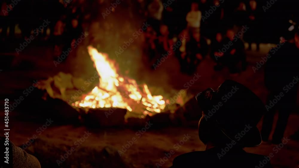 Male in a Hat Sits and Looks at the Bright Flame of a Night Bonfire in ...