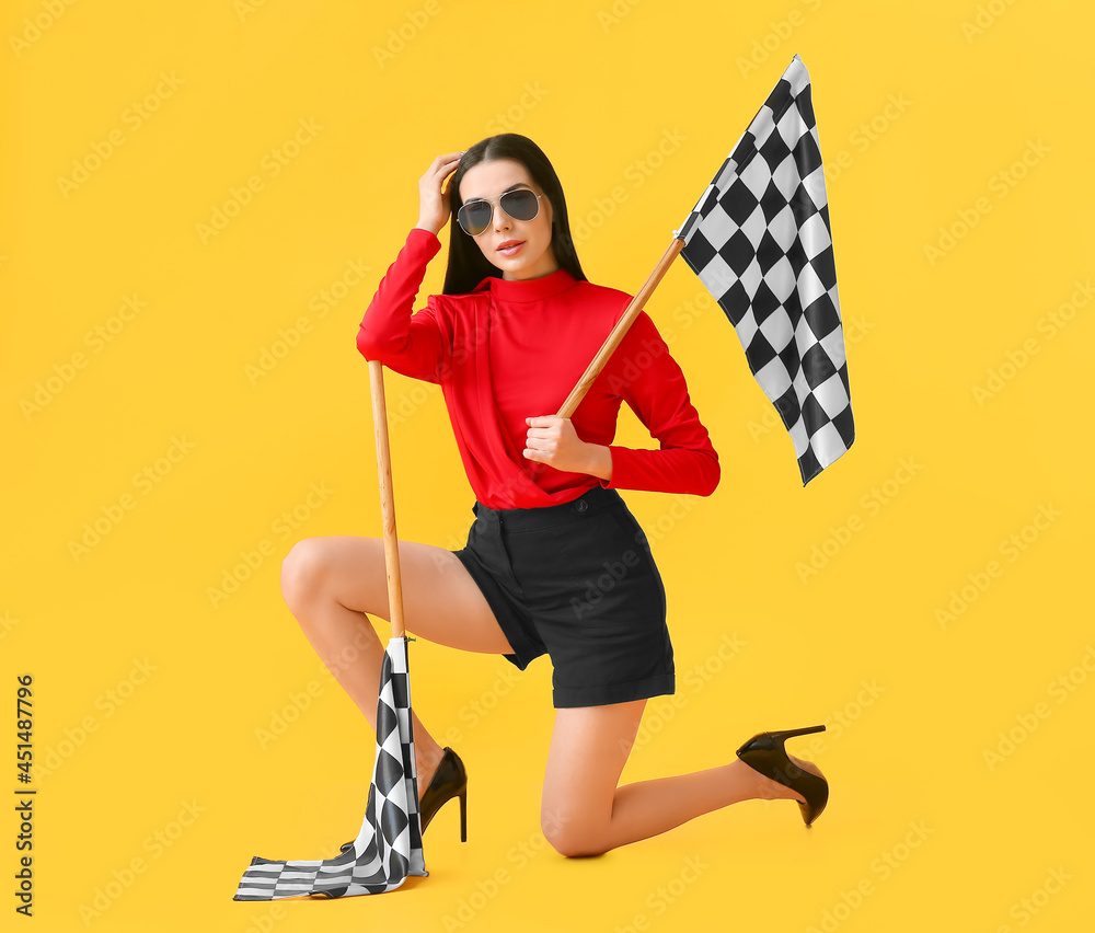 Beautiful young woman with racing flags on color background Stock Photo ...