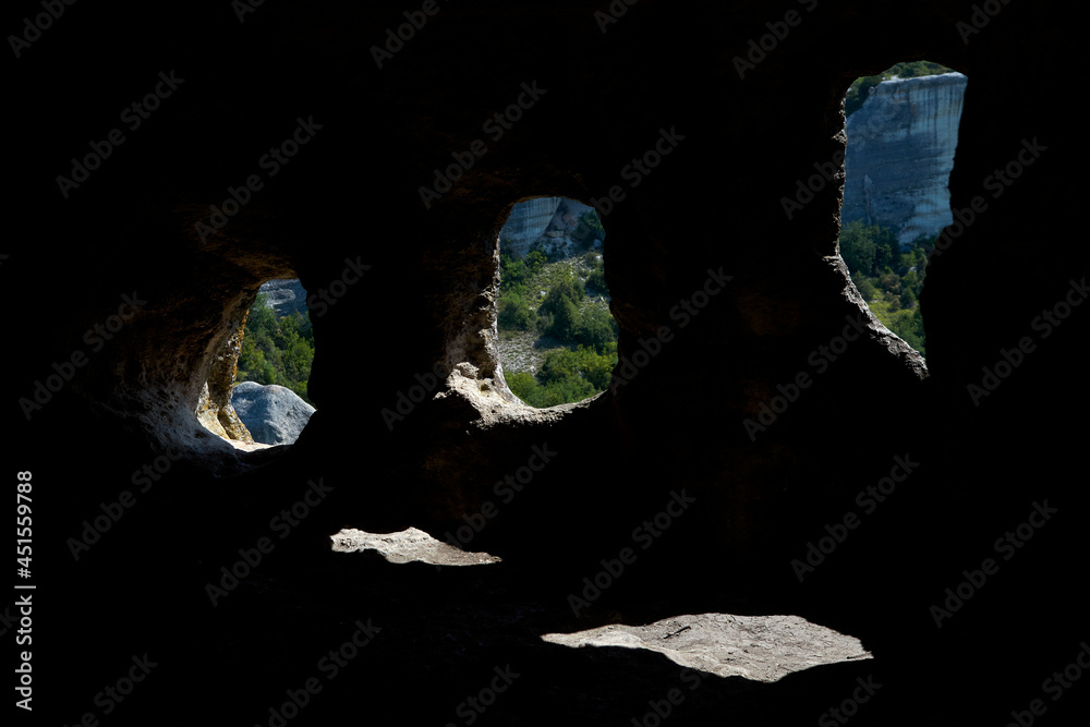 Ancient cave city. Inside the cave, view from the window. Medieval ...